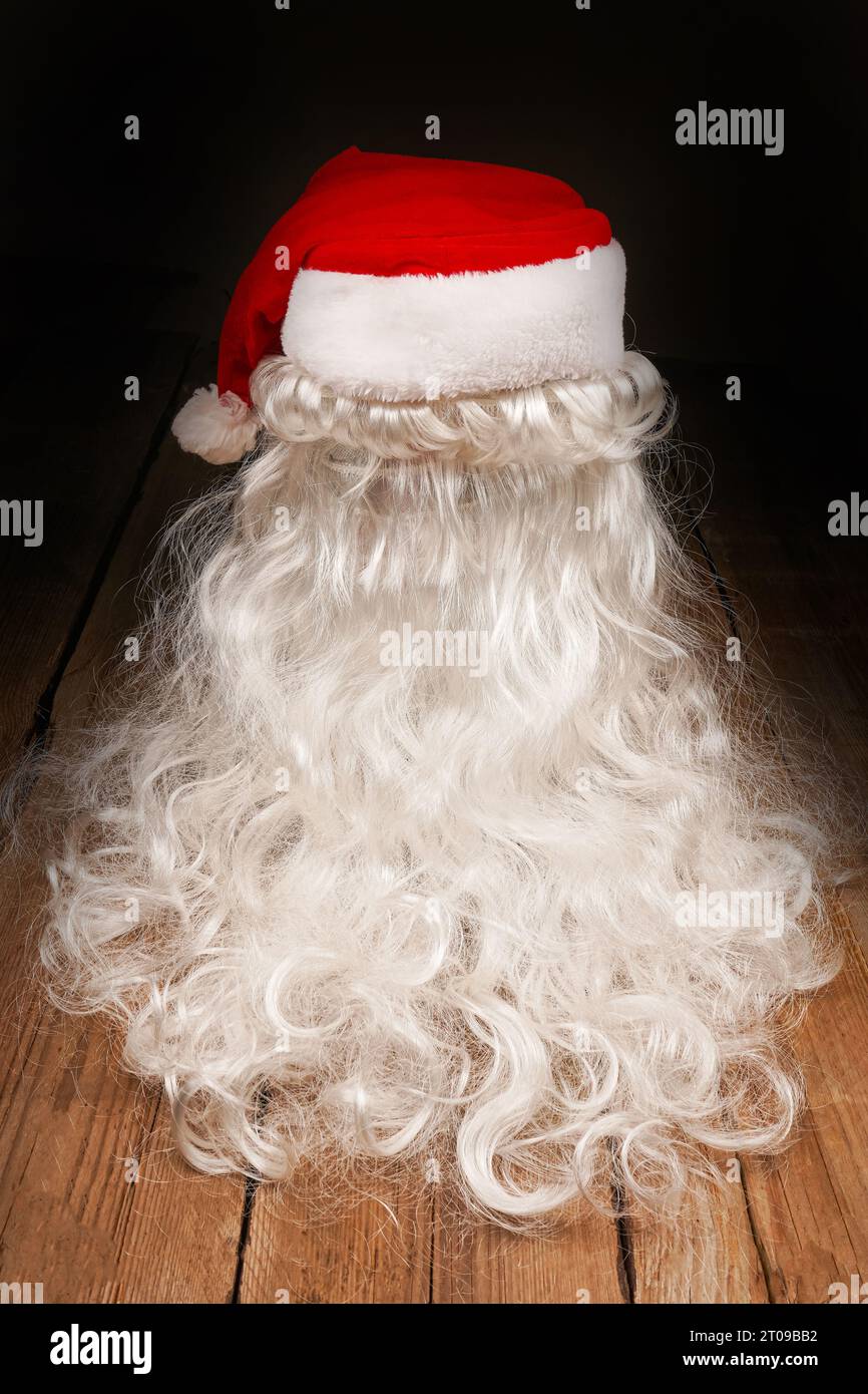 Santa hat and beard on a wooden background. Symbolism of New Year's ...