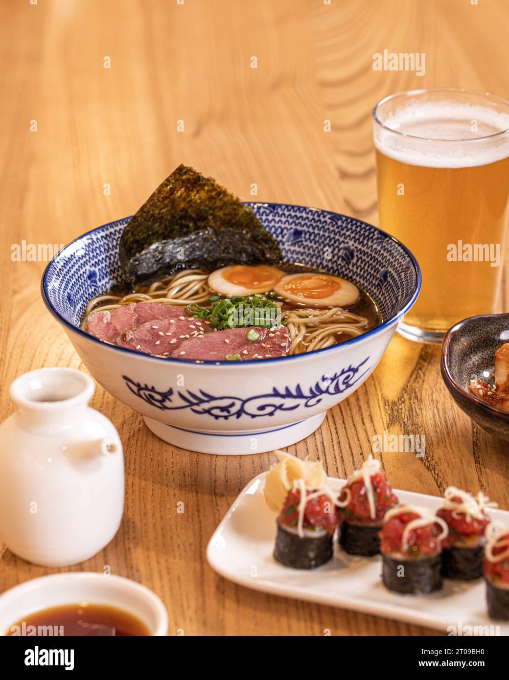 Table with japanese lunch dishes and beer Stock Photo - Alamy