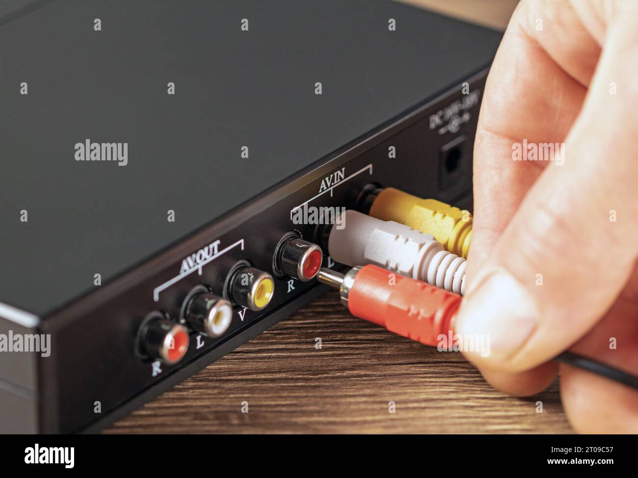 Close-up hand connecting a plug to a color music amplifier Stock Photo ...