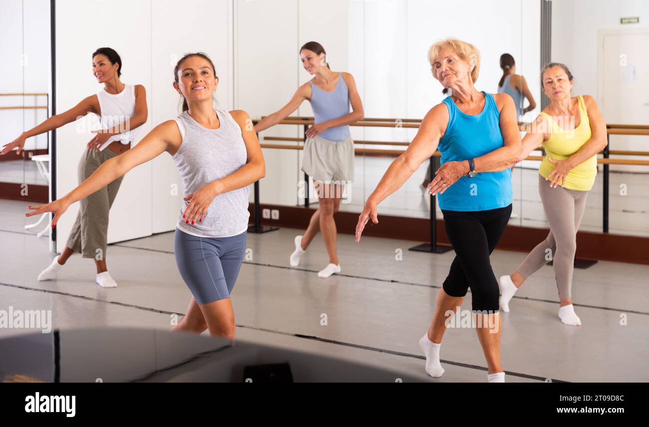 Group of active women practicing energetic dance in a studio Stock ...