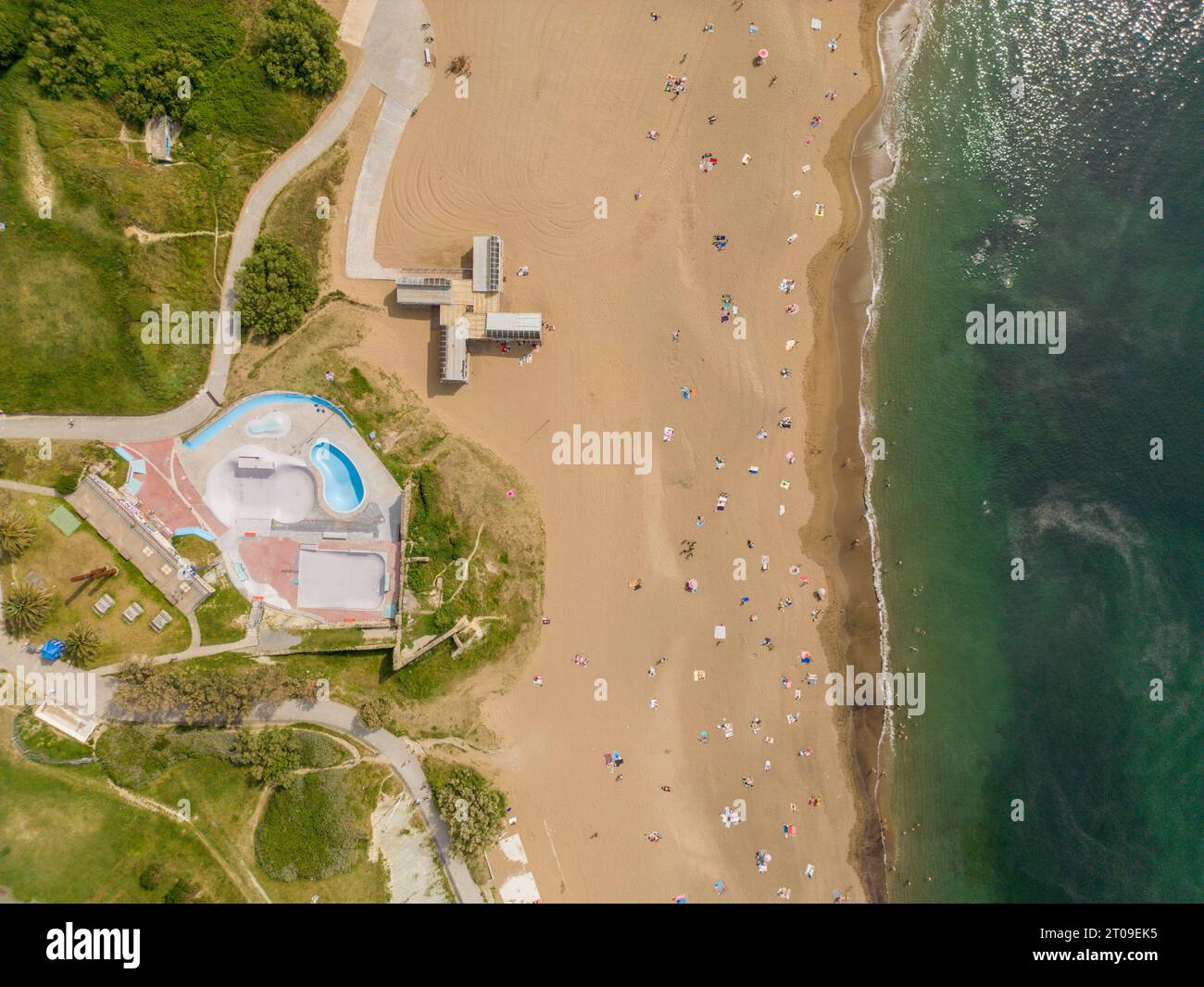 Aerial top view of resort hotel poolside and beach area with people ...
