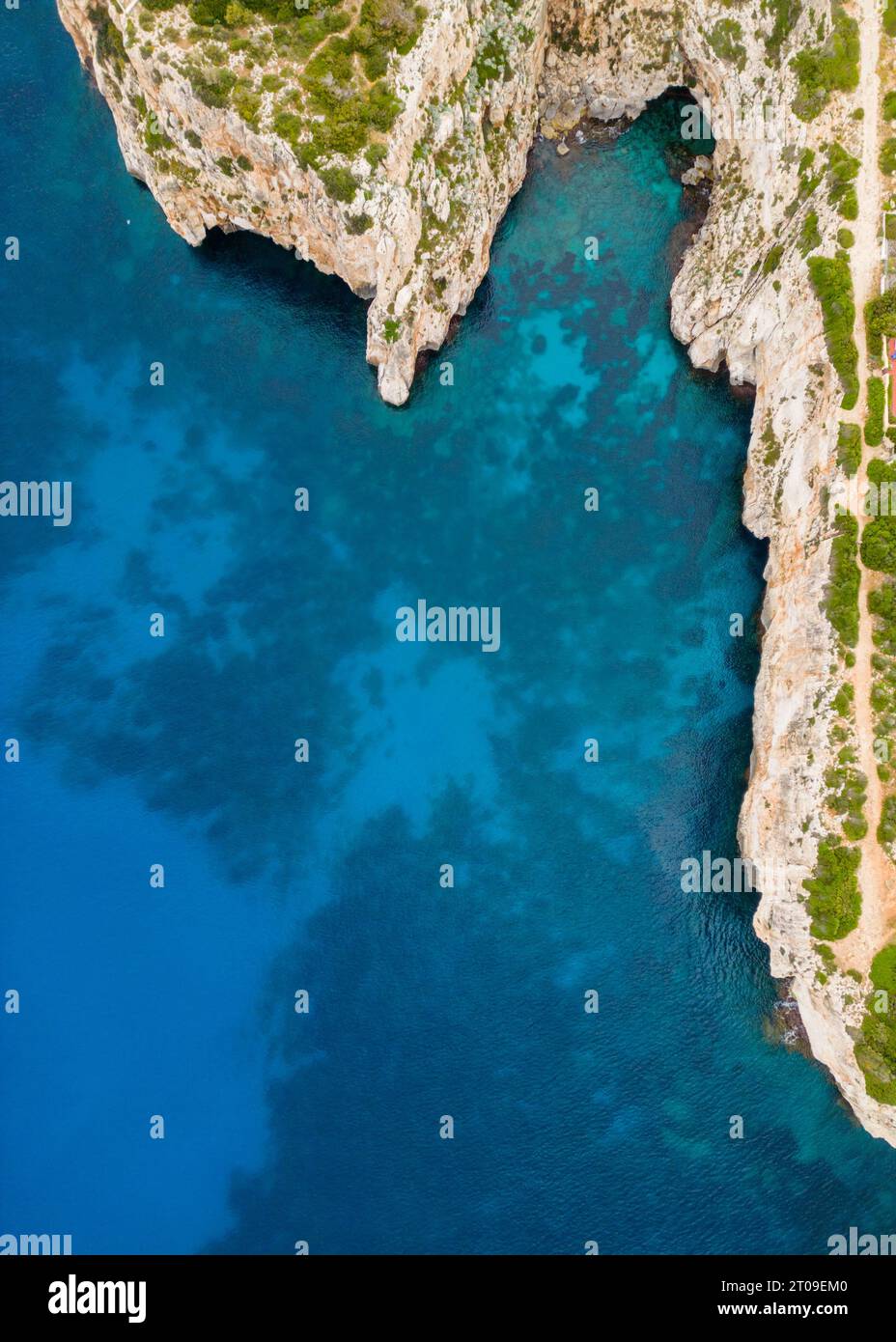 Drone view from eight of clear blue sea washing white cliffs with ...