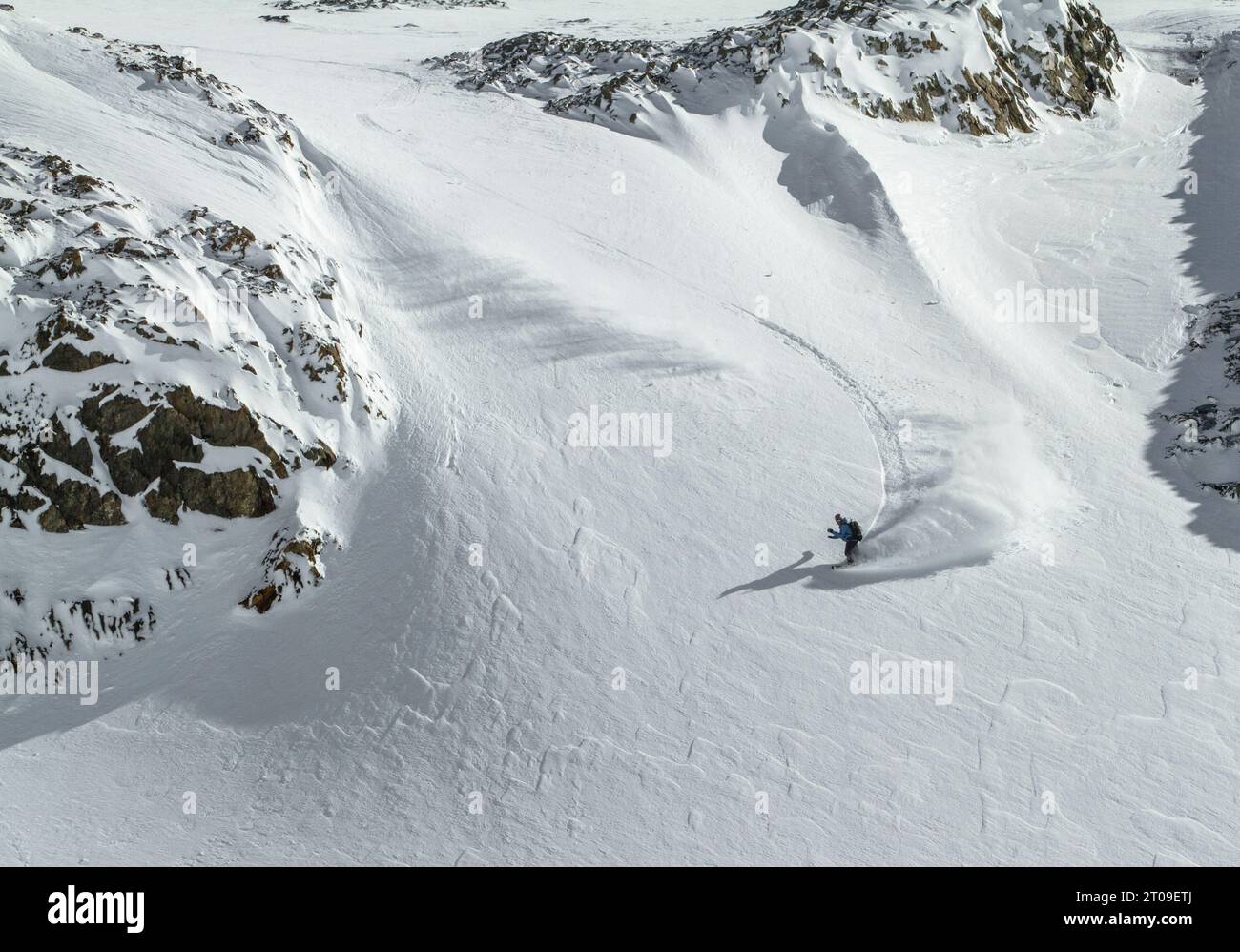 From above of anonymous snowboarder in warm ski suit and with ...