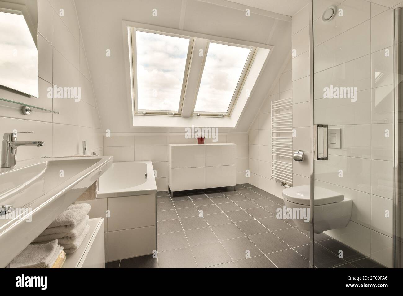 Interior of large modern bathroom with sink and bathtub by toilet seat ...
