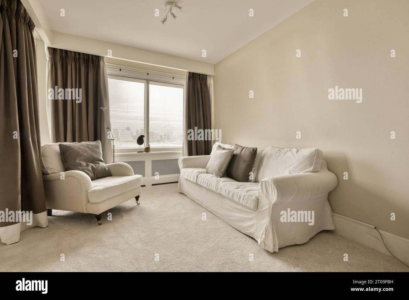 Interior of living room with white comfortable armchair and sofa by ...