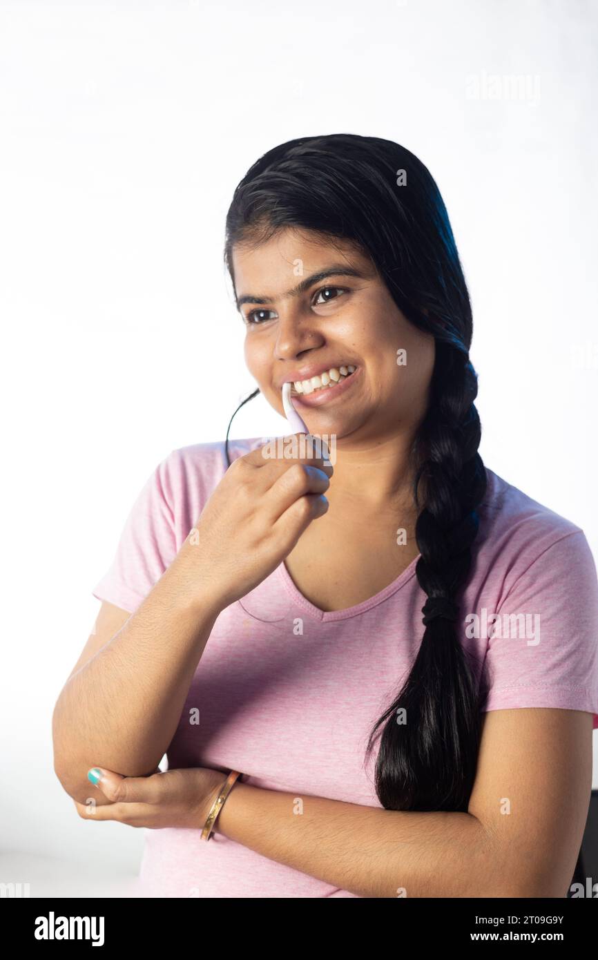 An Indian woman female girl brushing teeth on white background with ...