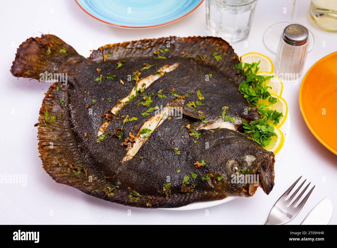 Roasted brill with lemon slices and herbs Stock Photo - Alamy