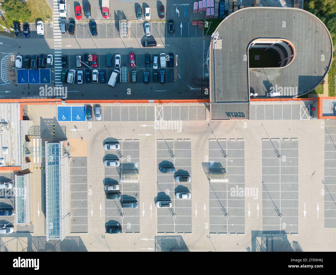 Aerial view of many colorful cars parked on parking lot with lines and ...