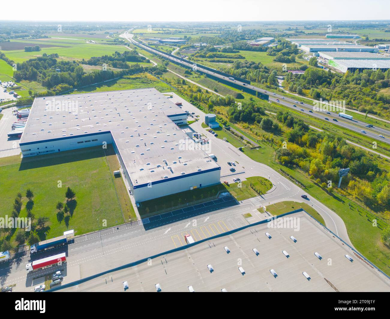 Logistics park with warehouse. Semi-trailers trucks standing on car ...