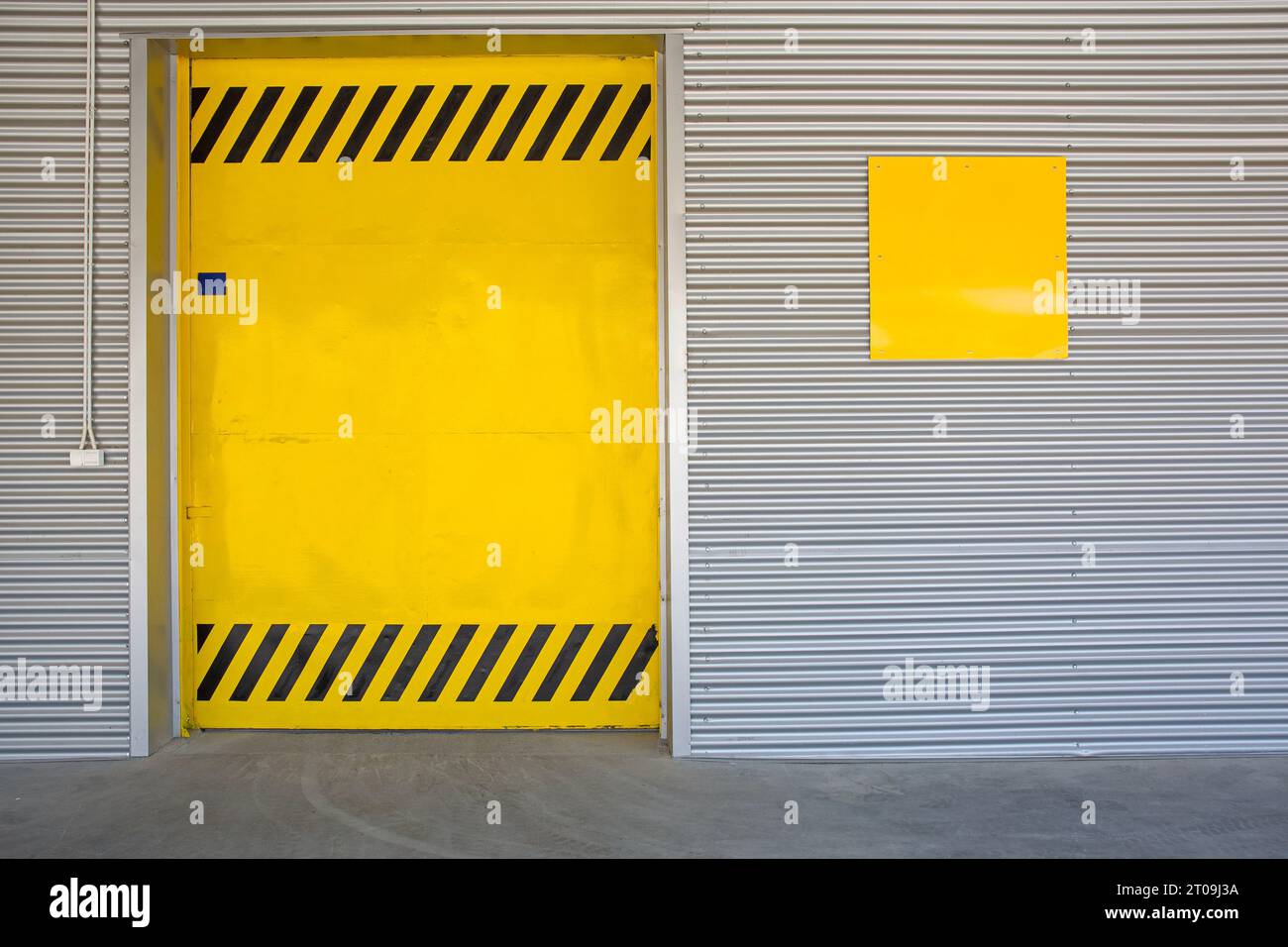 Big Yellow Gate Door at Distribution Warehouse Stock Photo - Alamy