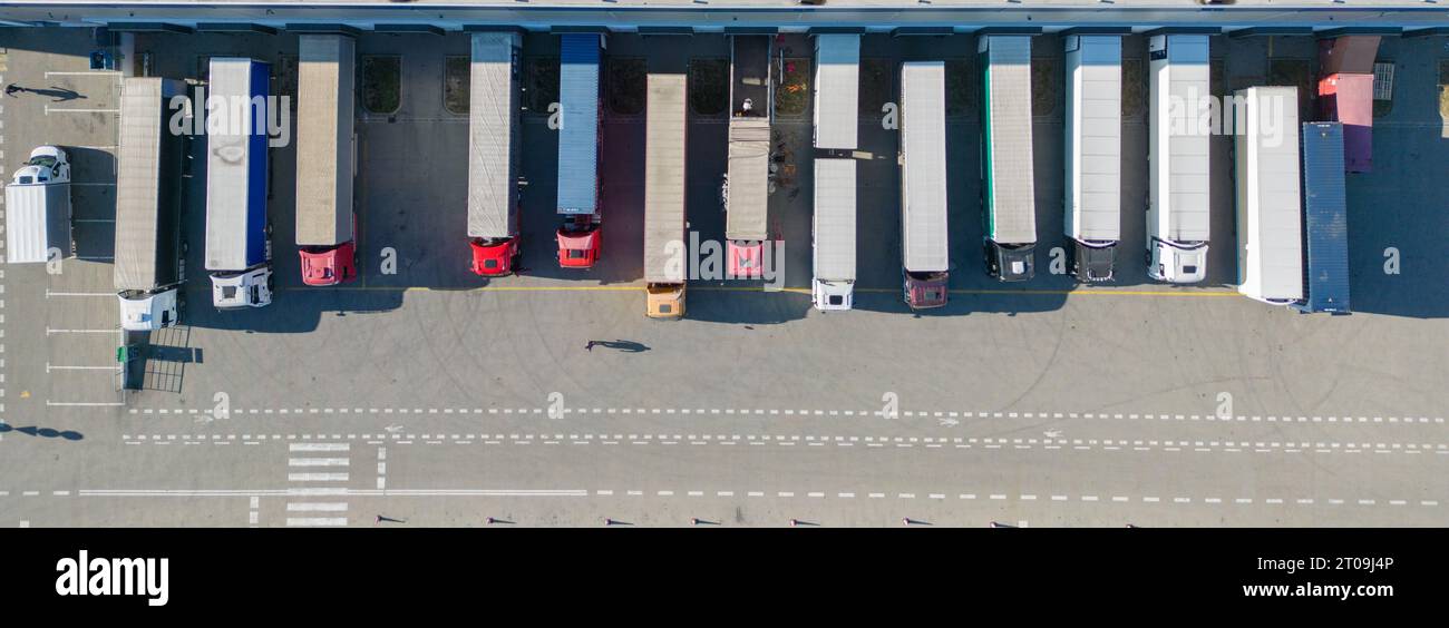 Logistics park with warehouse. Semi-trailers trucks standing on car ...