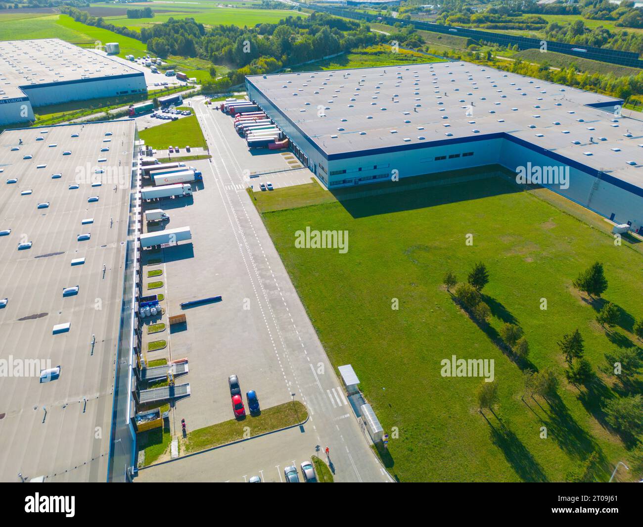 Logistics park with warehouse. Semi-trailers trucks standing on car ...