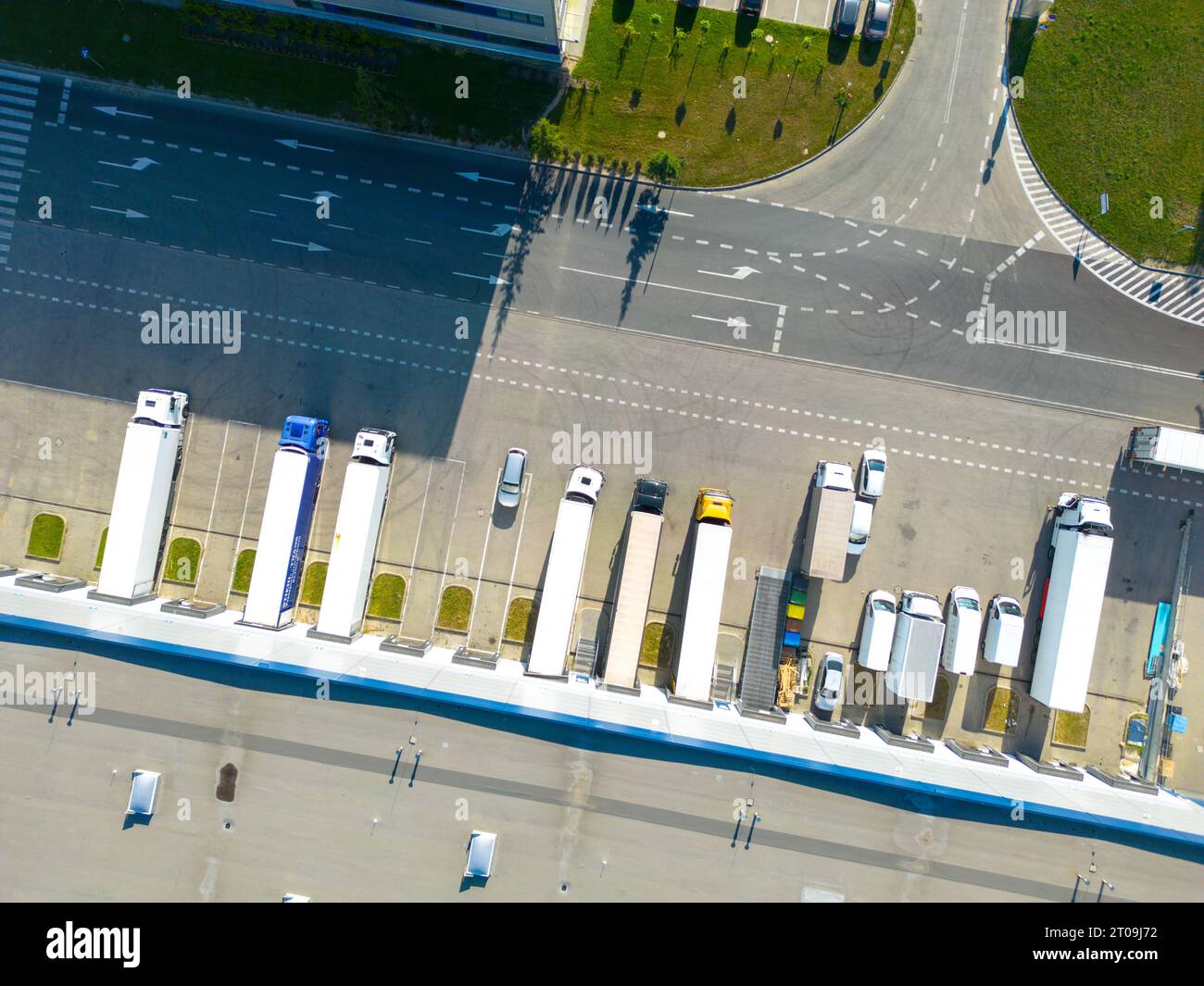 Logistics park with warehouse. Semi-trailers trucks standing on car ...