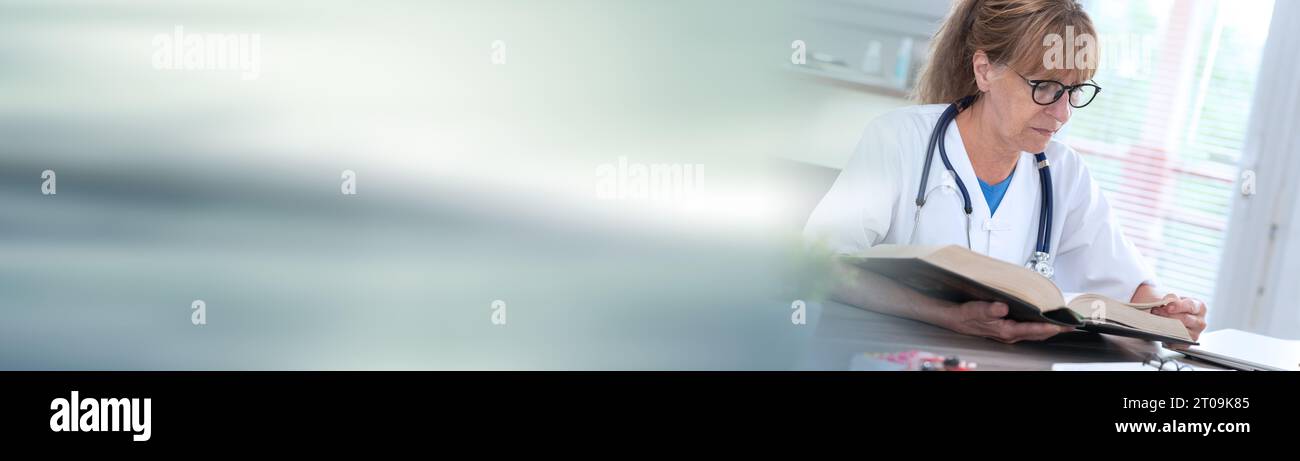 Female doctor reading a textbook in medical office; panoramic banner ...