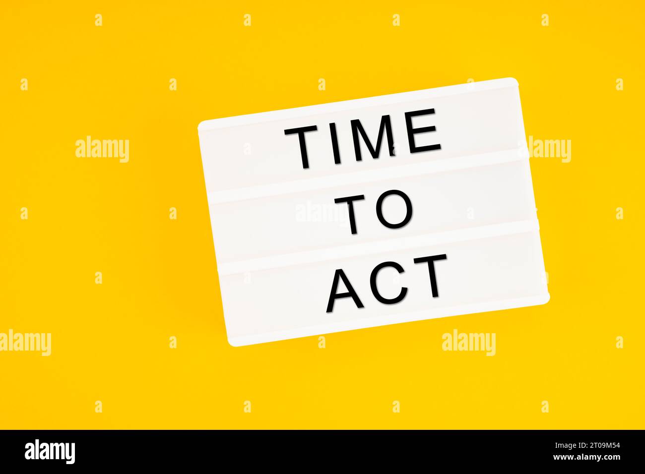 Time to act text on white lightbox sitting on yellow background ...