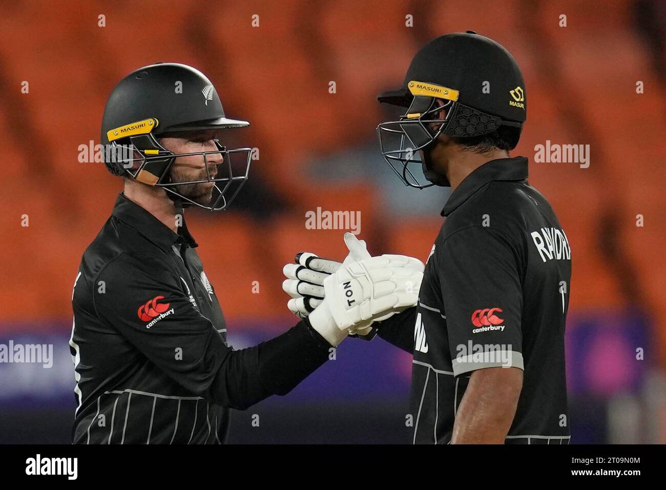 New Zealand's Rachin Ravindra, right, is congratulated by teammate New Zealand's Devon Conway ...