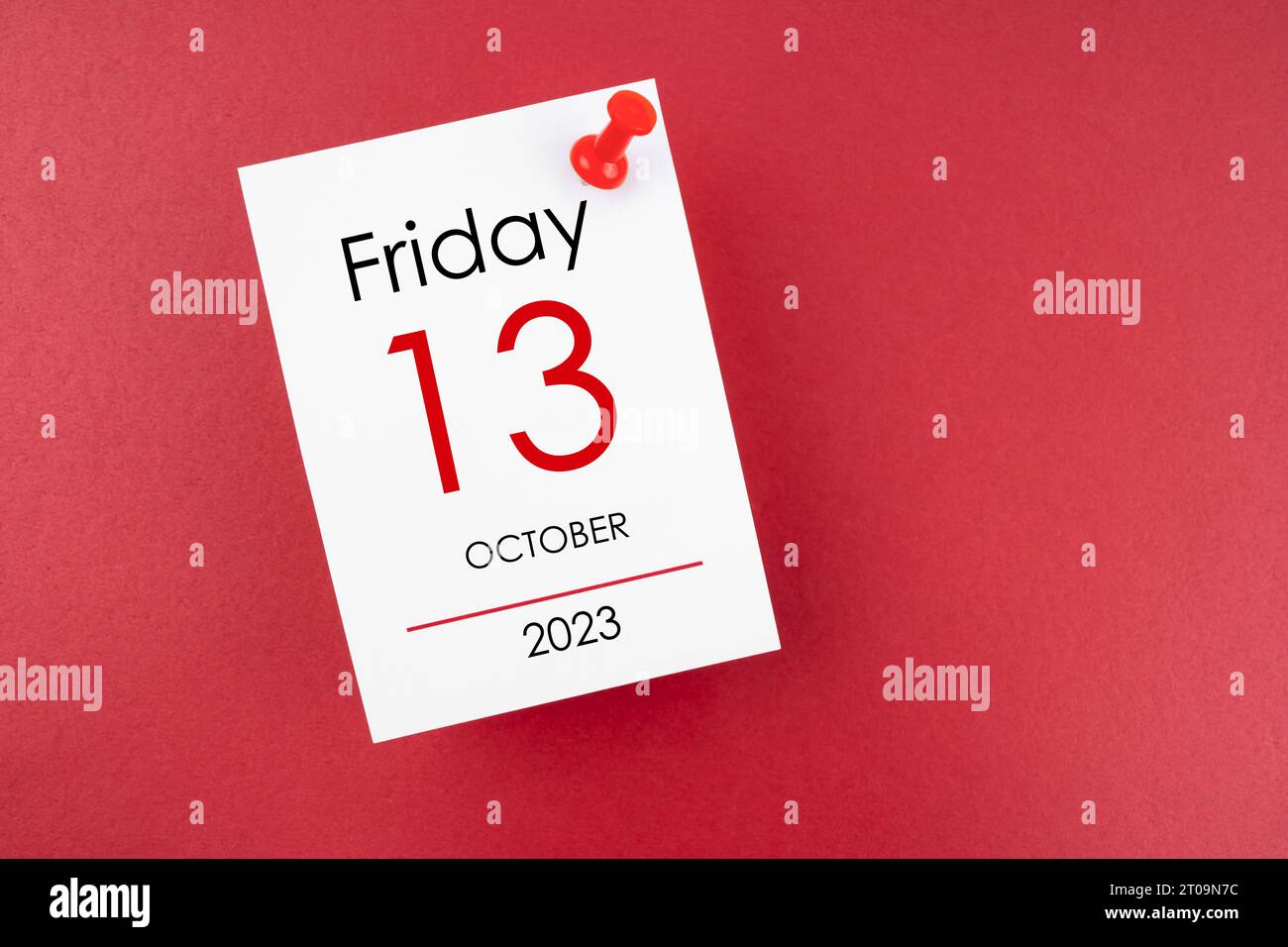 Calendar Friday the 13th October 2023 and push pin on red background ...