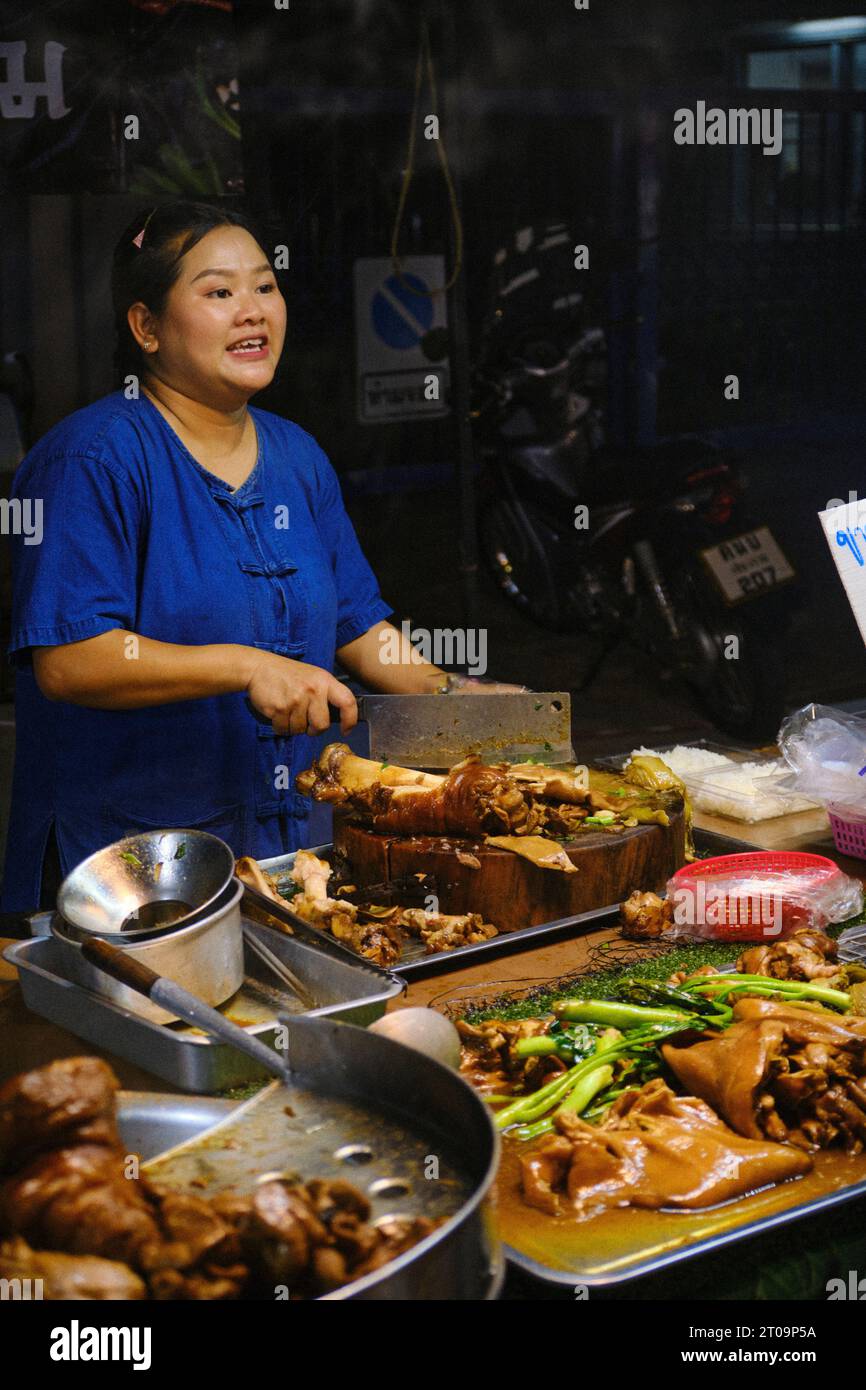 Thai woman cutting pork hi-res stock photography and images - Alamy