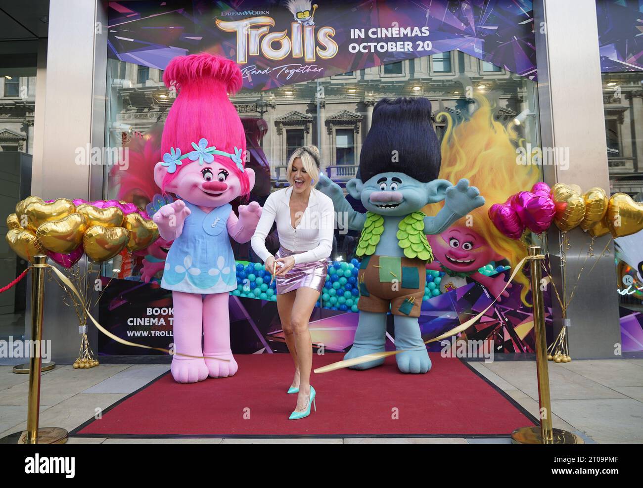 Ashley Roberts cuts a ribbon to officially open the Trolls Happy Place ...