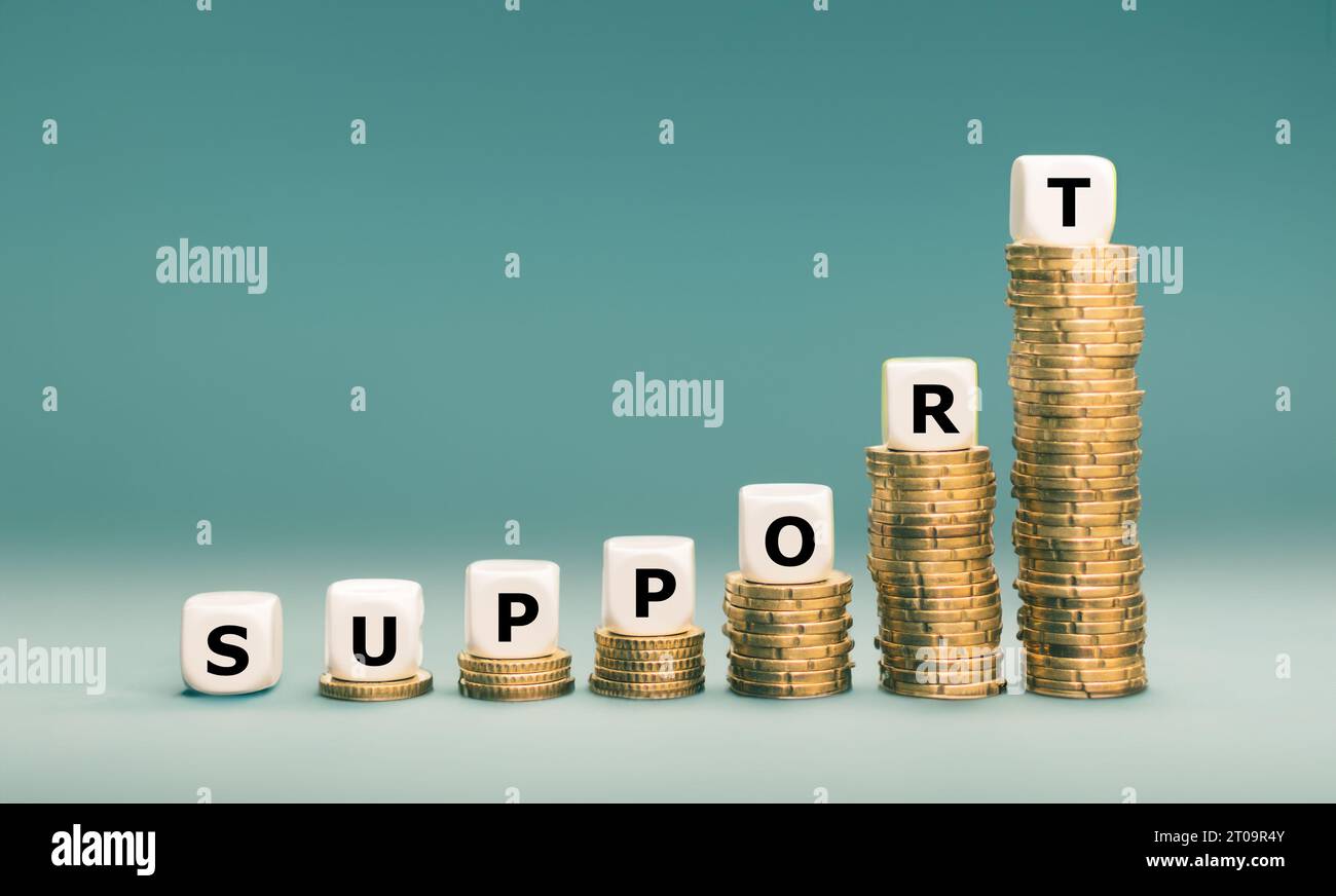 Dice form the word 'support' on increasing high stacks of coins. Symbol ...