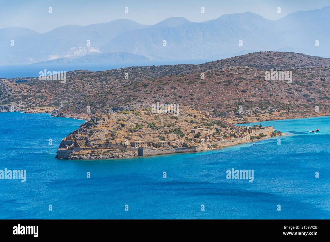 Panoramic view of the island of Spinalonga with calm sea. Here were ...
