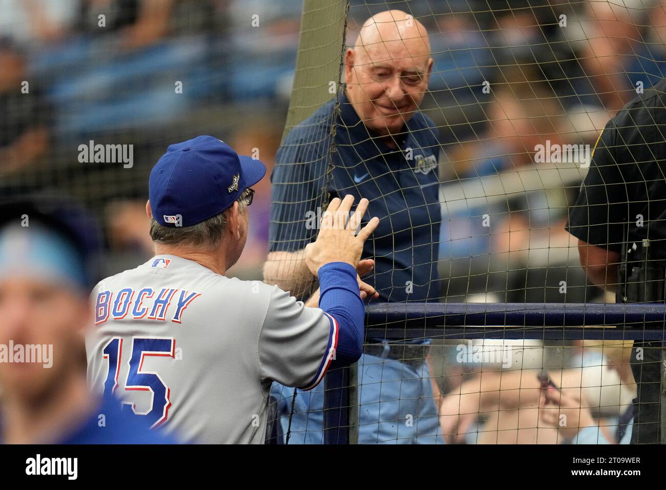 Texas Rangers manager Bruce Bochy (15) greets basketball sportscaster ...
