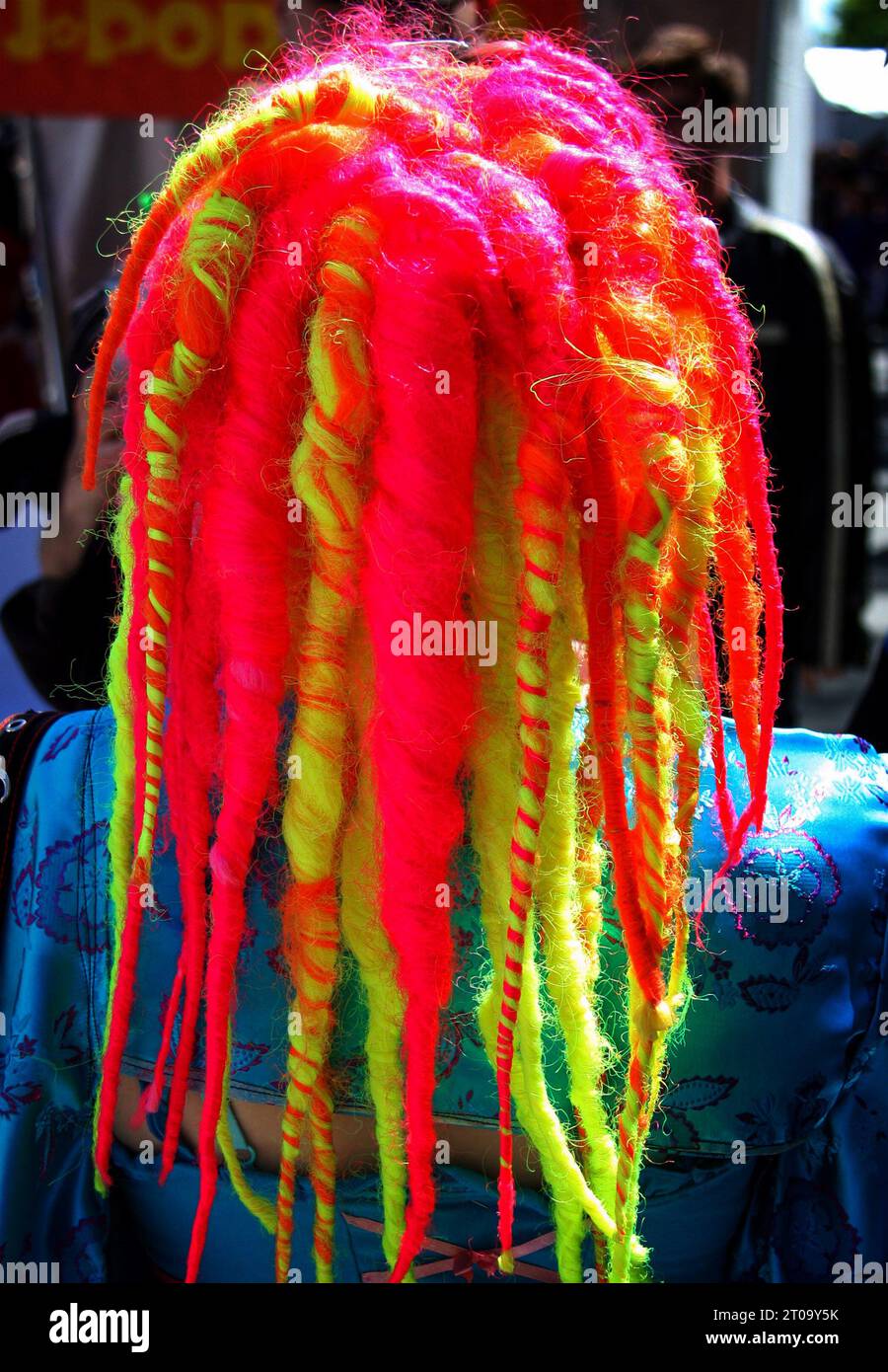 Red and yellow dreadlocks at a street festival Stock Photo - Alamy