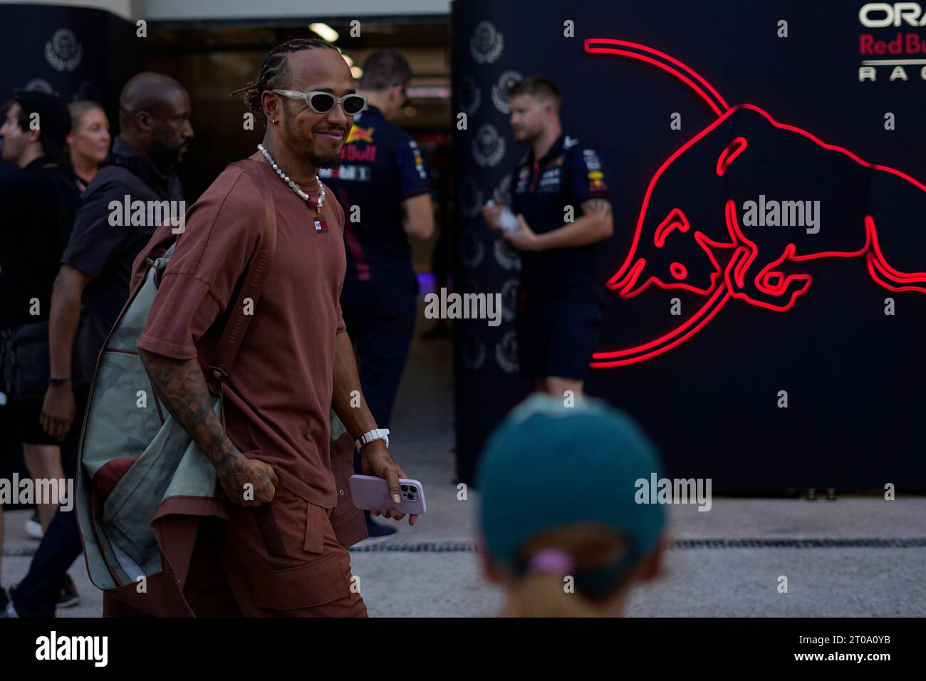 Mercedes driver Lewis Hamilton of Britain walks through the paddock at ...