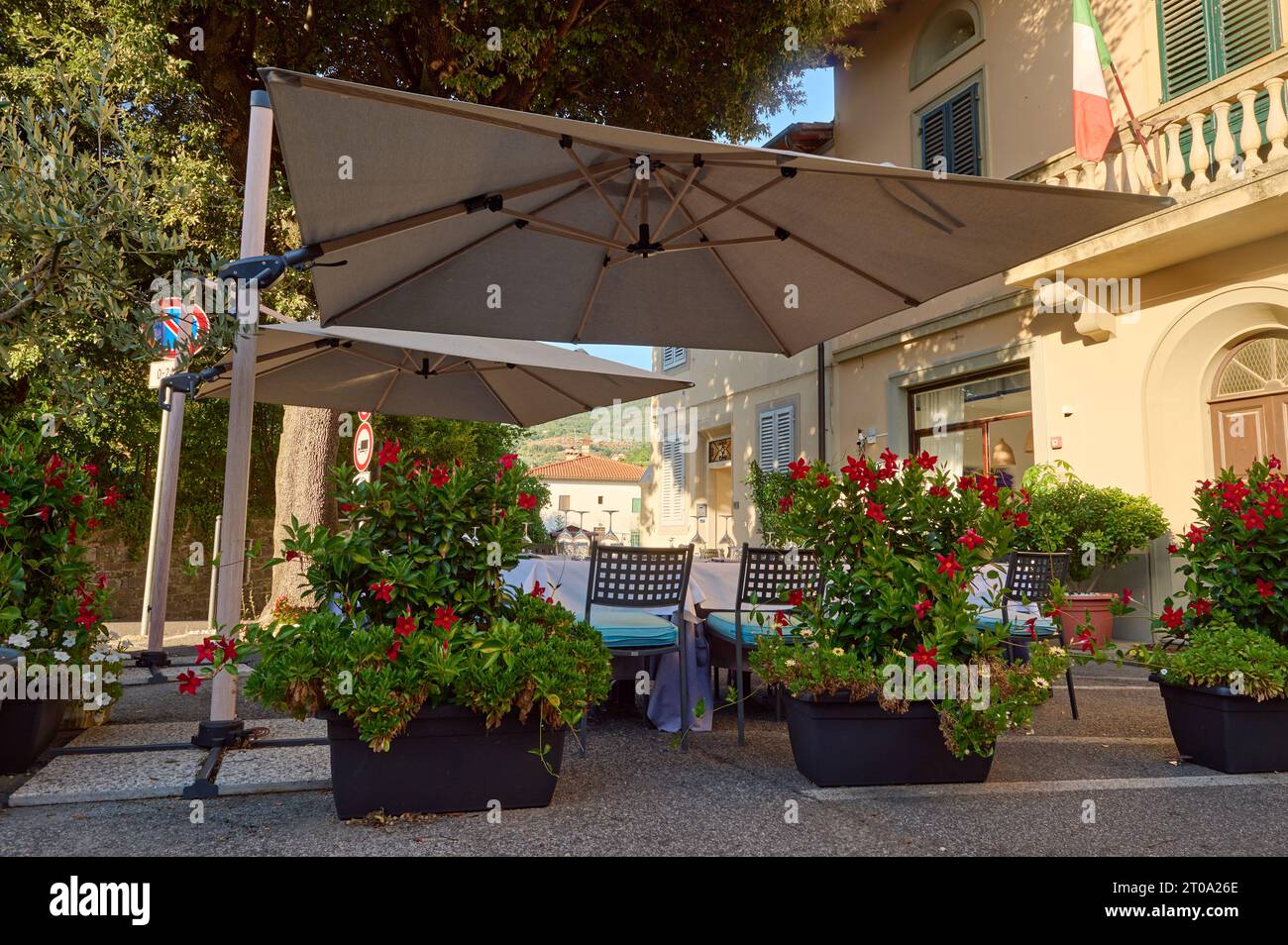 Cozy street with tables of cafe old town street in Reggello village, in ...