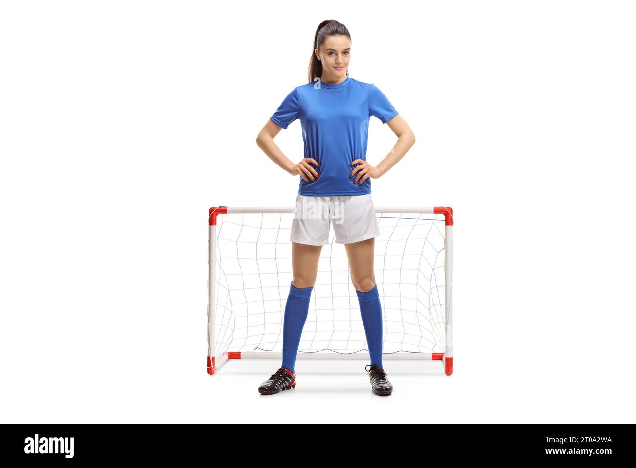 Full length portrait of a female football player standing in front of a ...