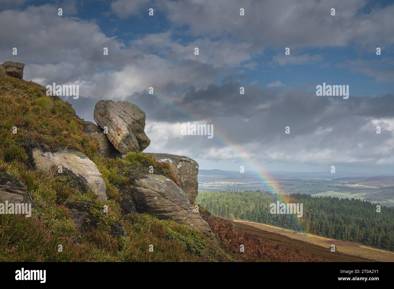 Rainbow over Simonside Hills and crags. View towards The Cheviots ...