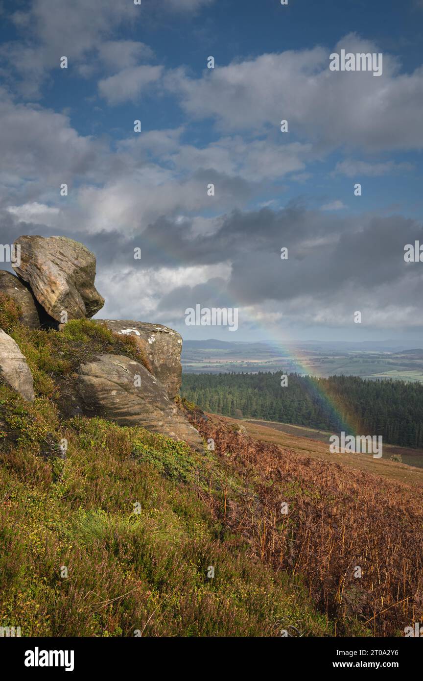 Rainbow over Simonside Hills and crags. View towards The Cheviots ...