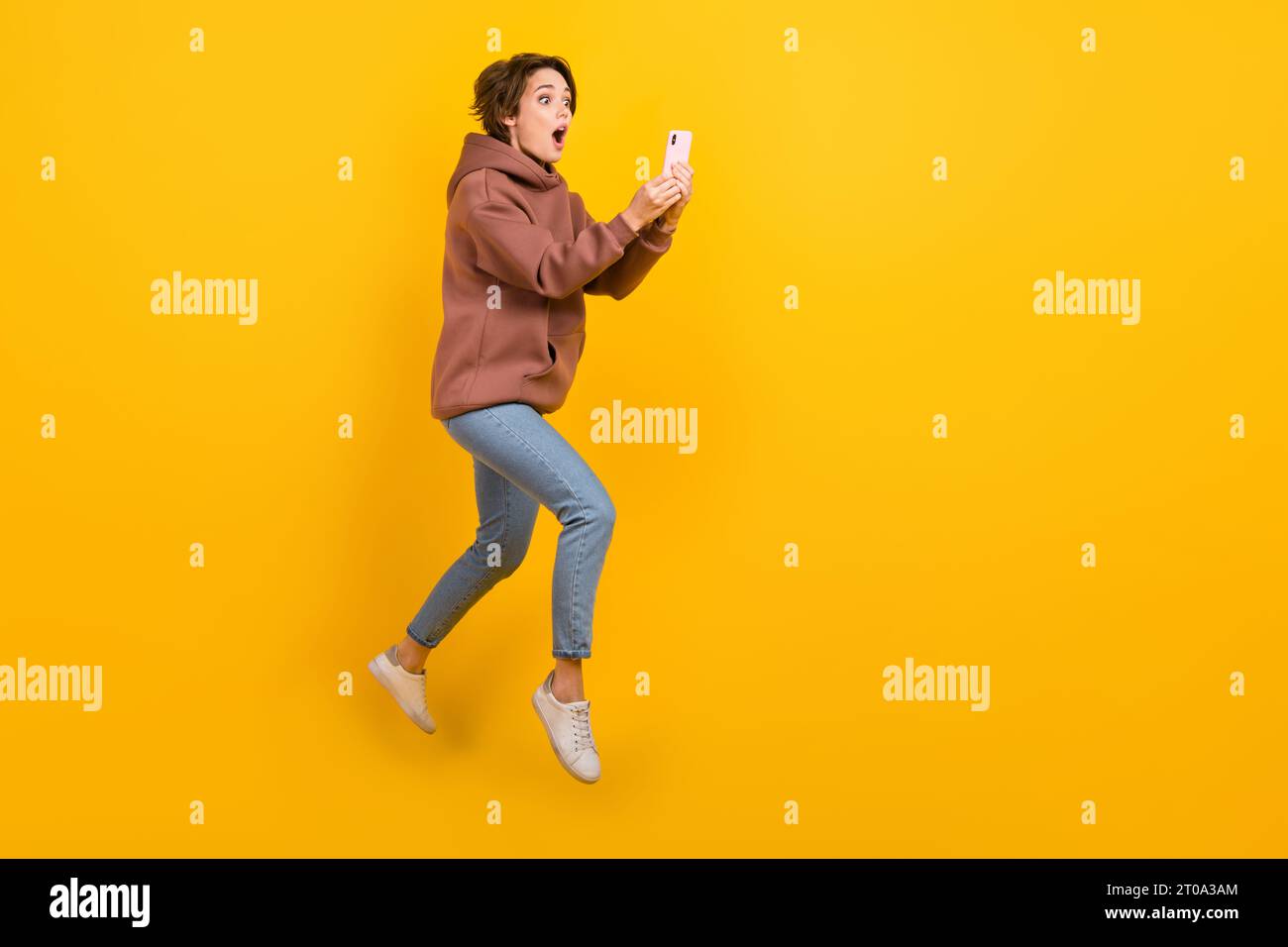 Full length photo of impressed person jump rush use smart phone empty ...