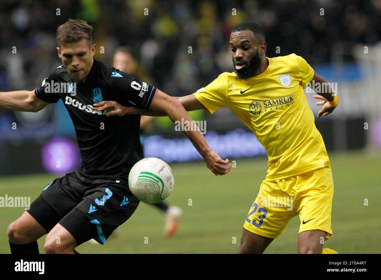 Plzen's Robin Hranac, left, challenges for the ball with Astana's ...