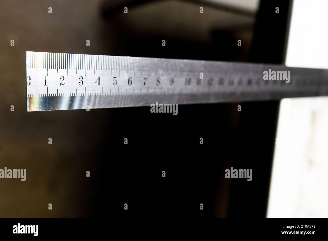 iron ruler with numbers on black background Stock Photo - Alamy