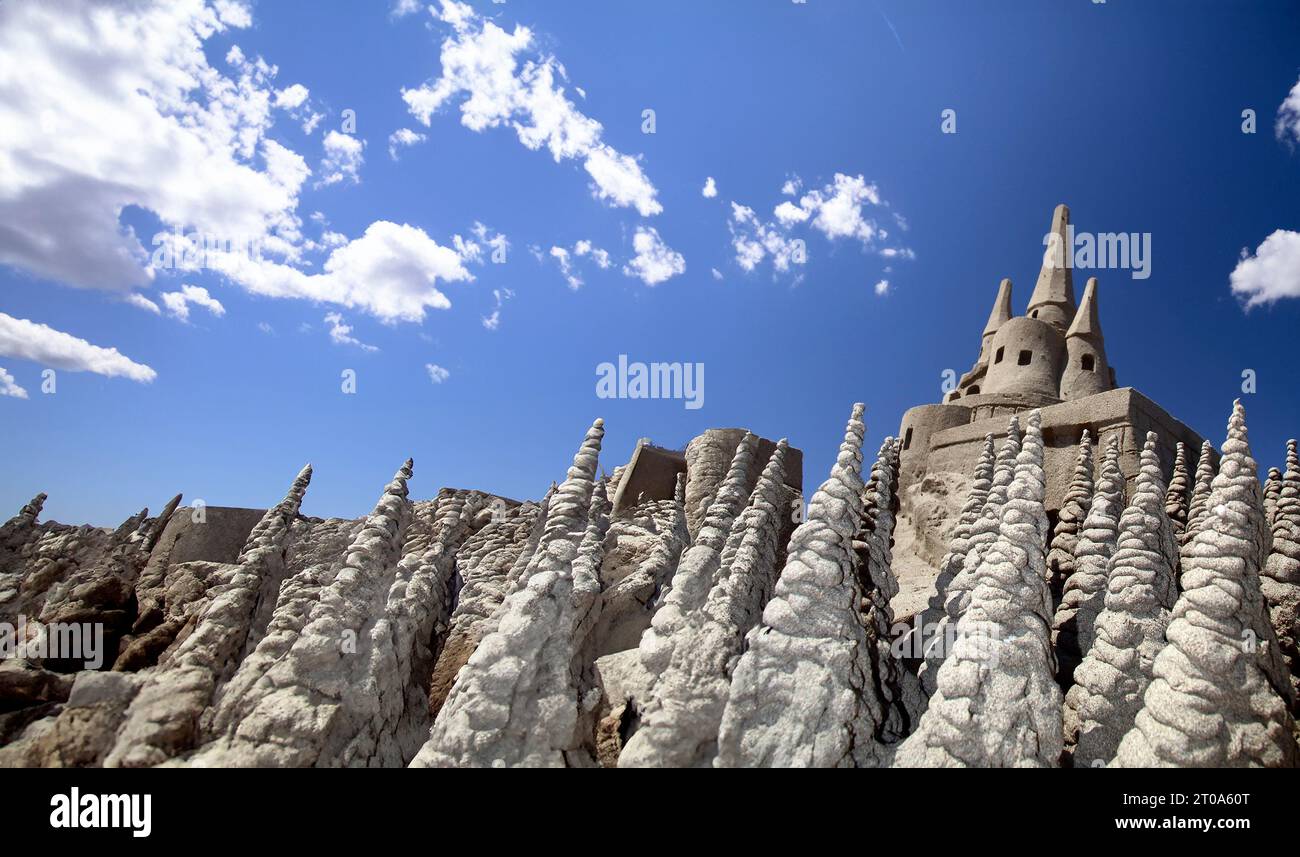 A castle sculpted from sand stands proudly on the beach, a temporary ...