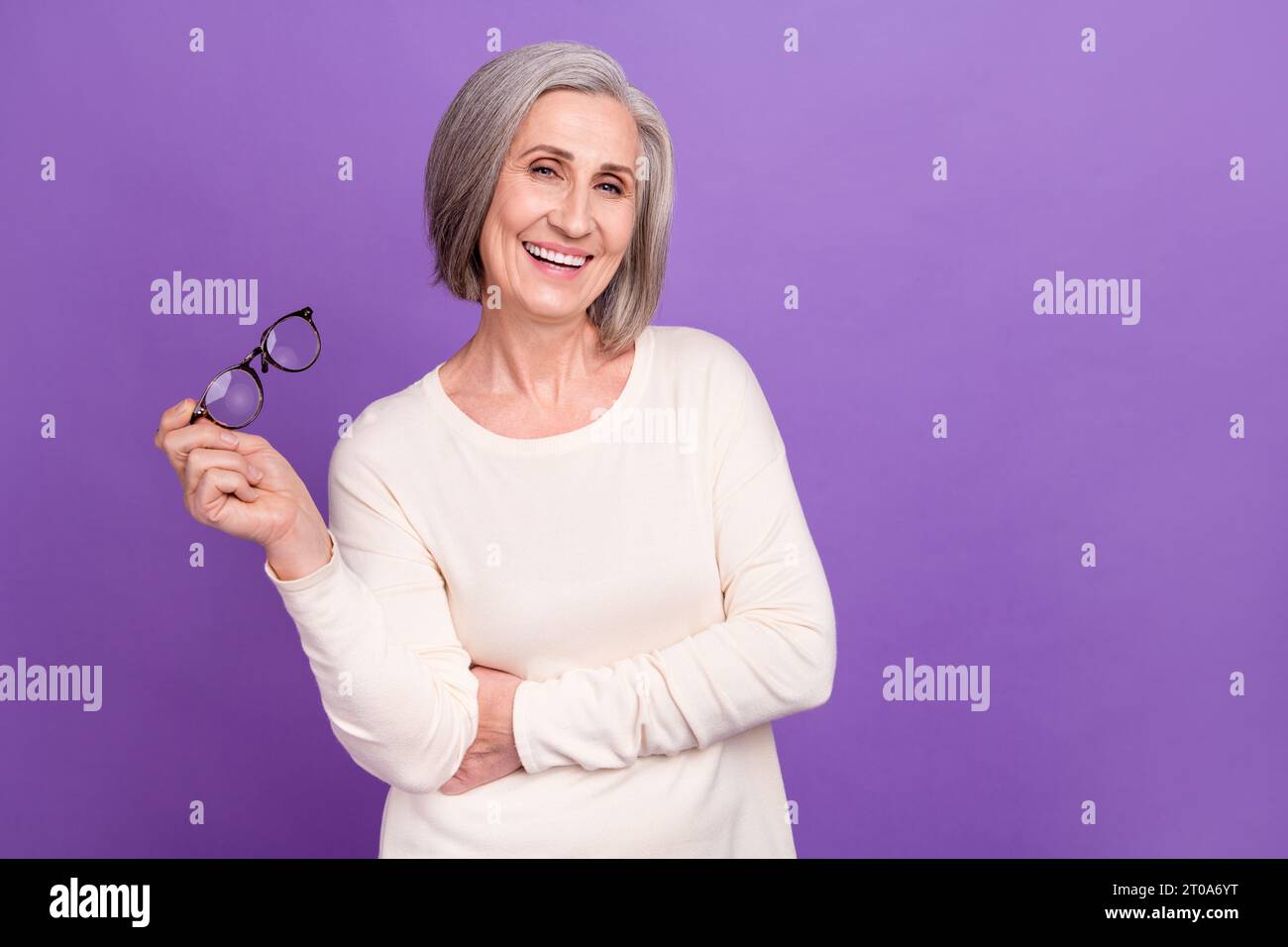 Portrait of beautiful senior businesswoman taking off her eyeglasses ...