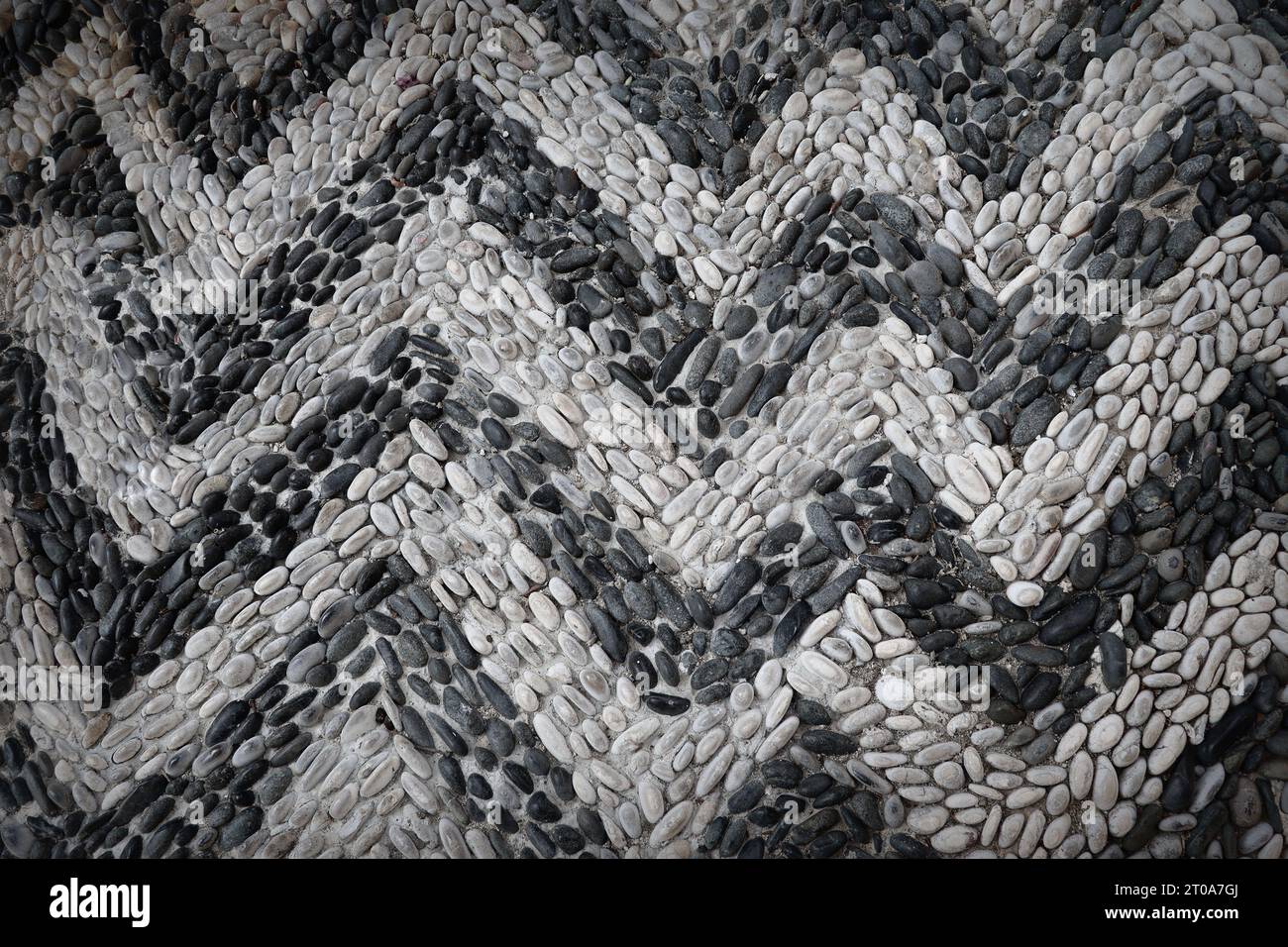 Pebble stone mosaic pavement with simple pattern in Greece town Stock ...