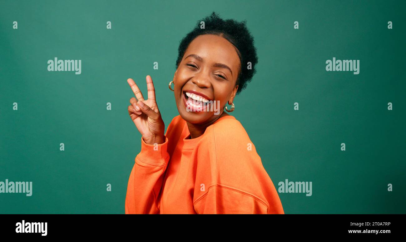 Happy young woman holds peace hi-res stock photography and images - Alamy