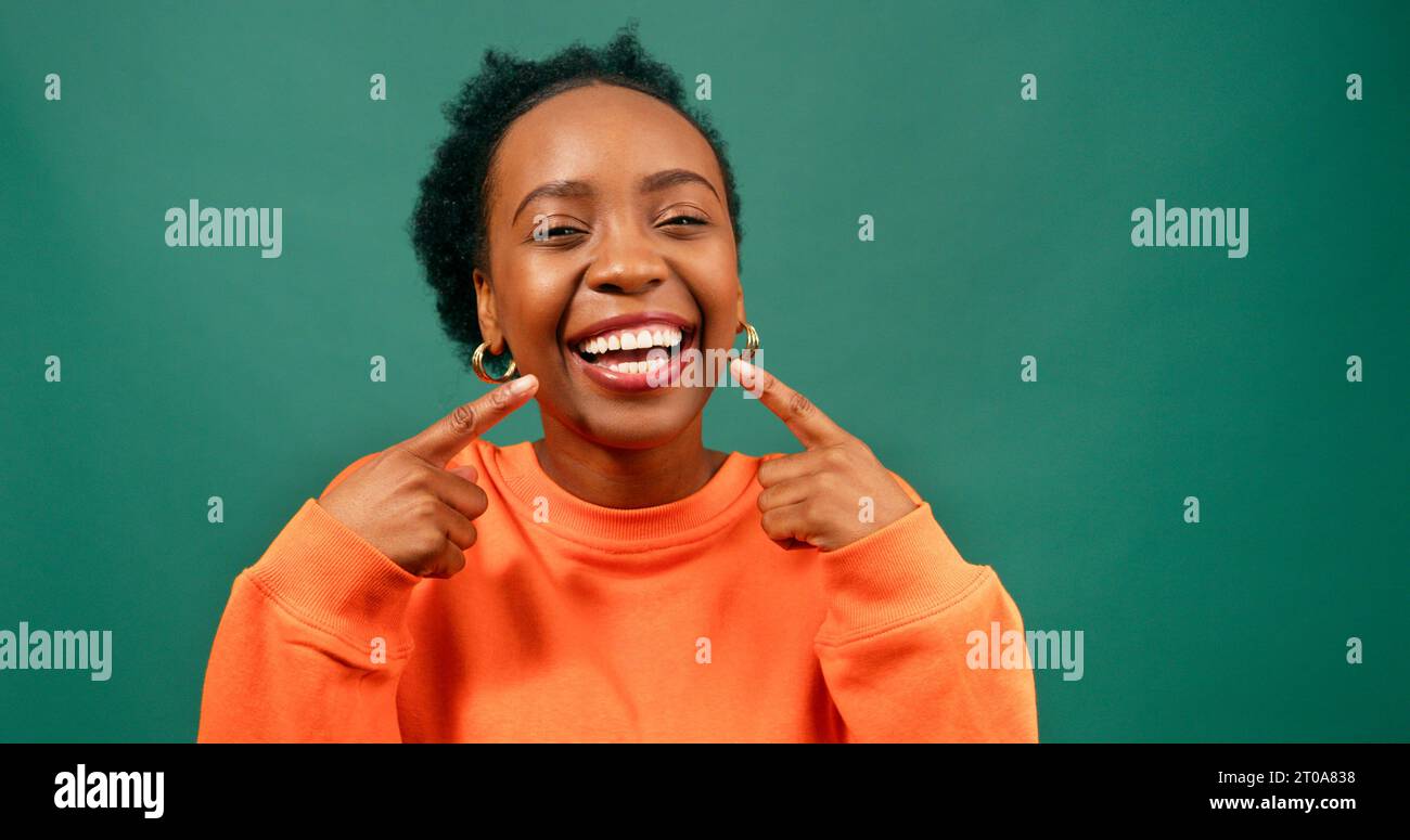 Woman points fingers teeth hi-res stock photography and images - Alamy