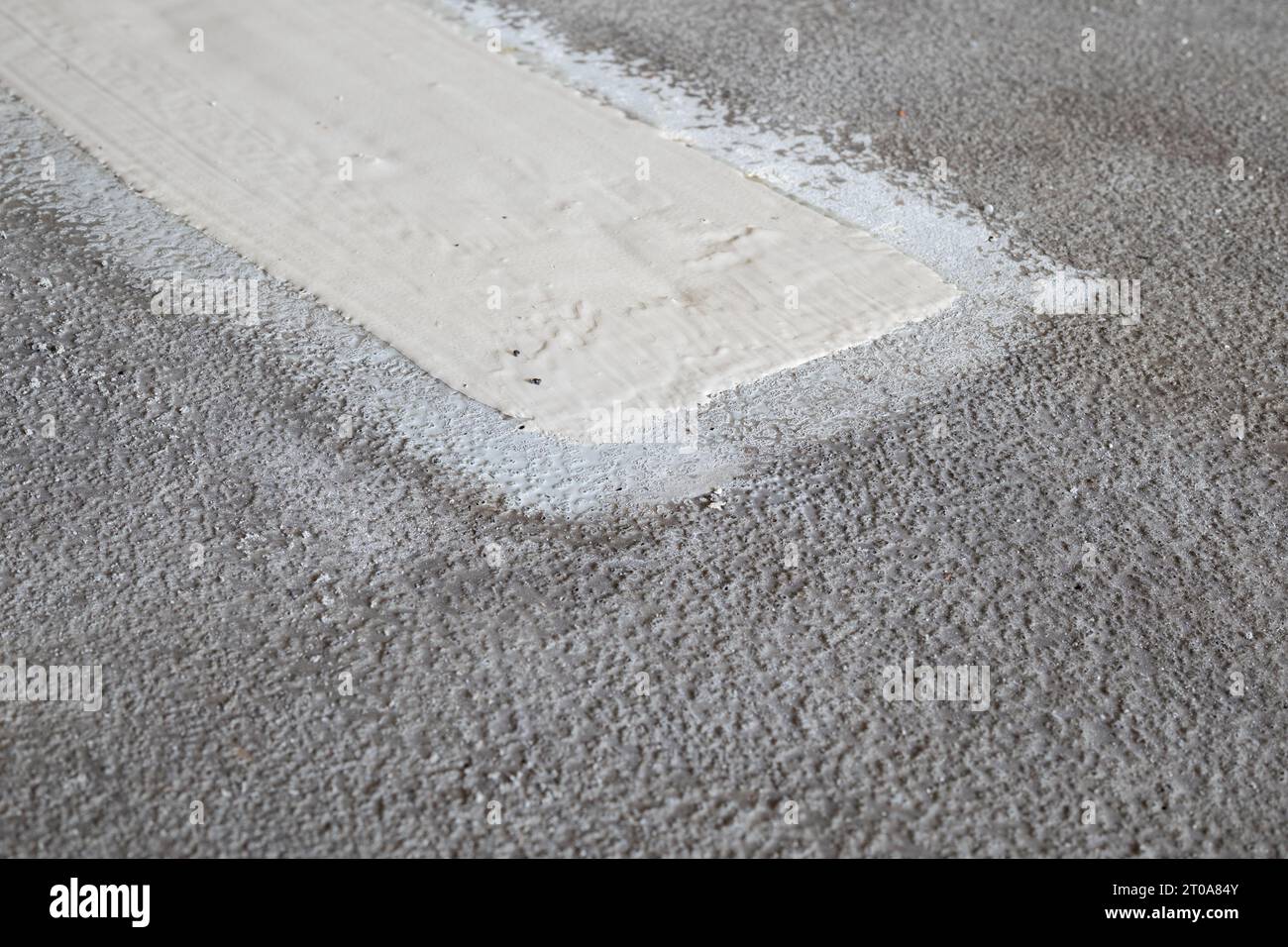 Driveway or road repair patch up with waterproofing sealant. Polymethyl ...