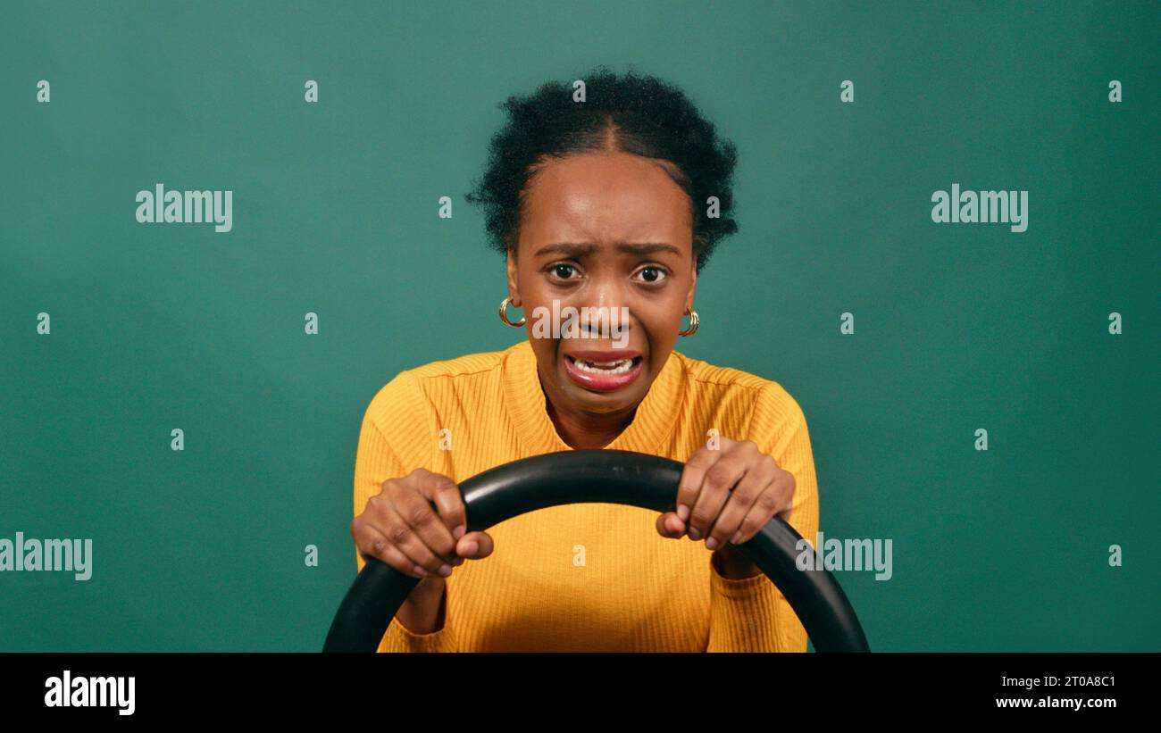 Scared and nervous learner driver behind the wheel, driving studio ...