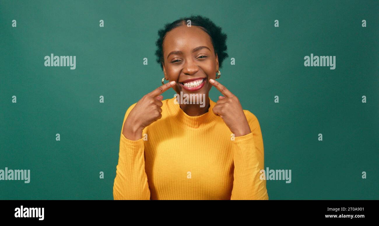 Woman points teeth hi-res stock photography and images - Alamy