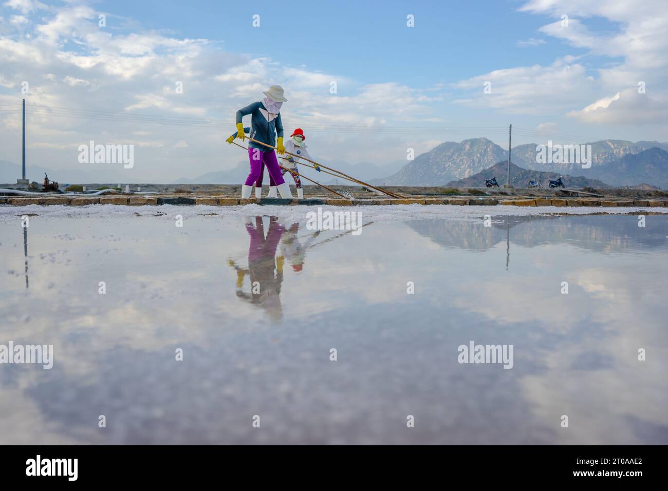 Salt farmers are making salt, the salt fields are pure white, men and ...