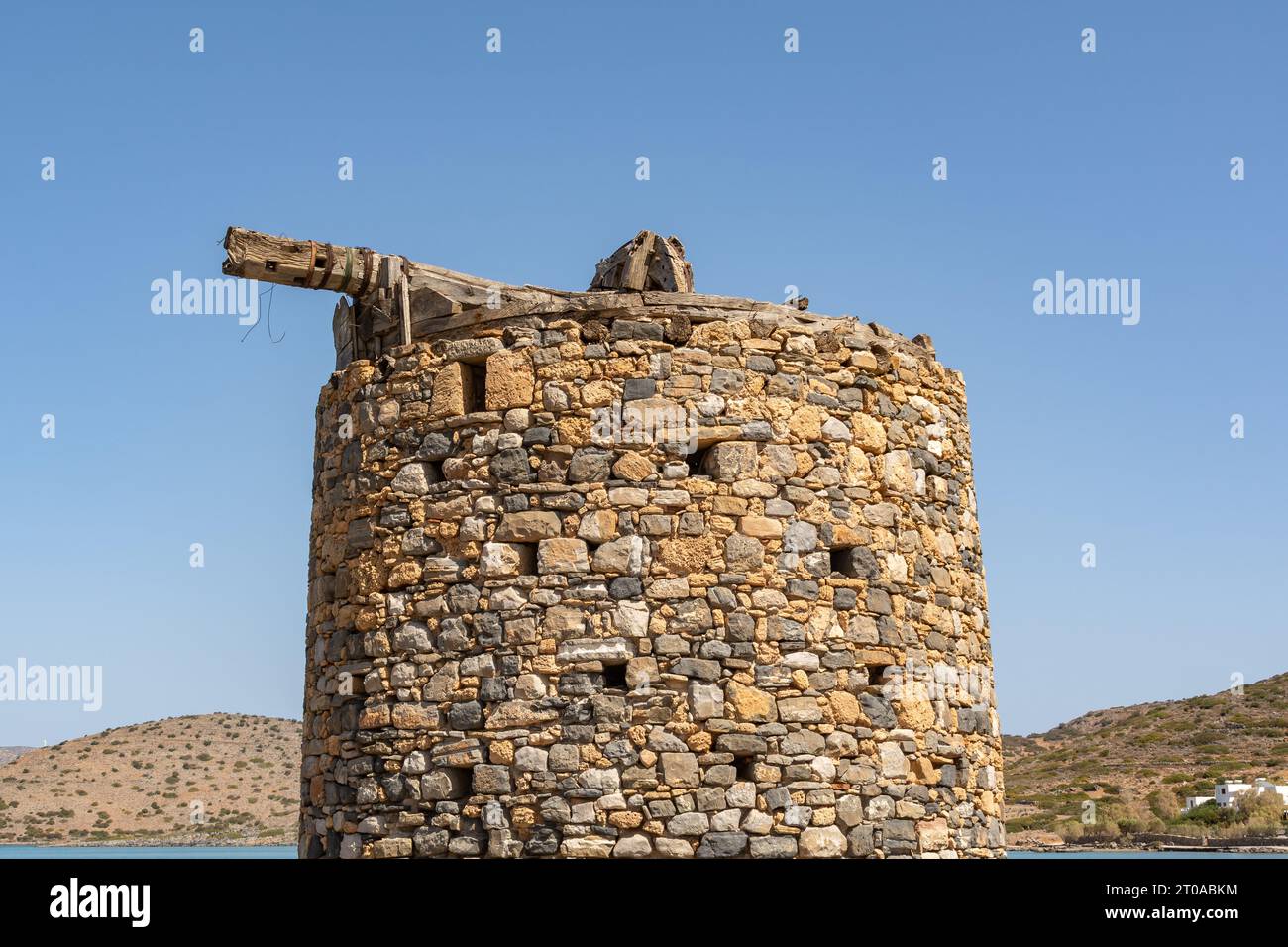 The ruins of ancient windmills along the beach in the Elounda region of ...