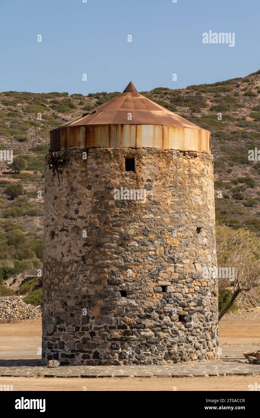 The ruins of ancient windmills along the beach in the Elounda region of ...