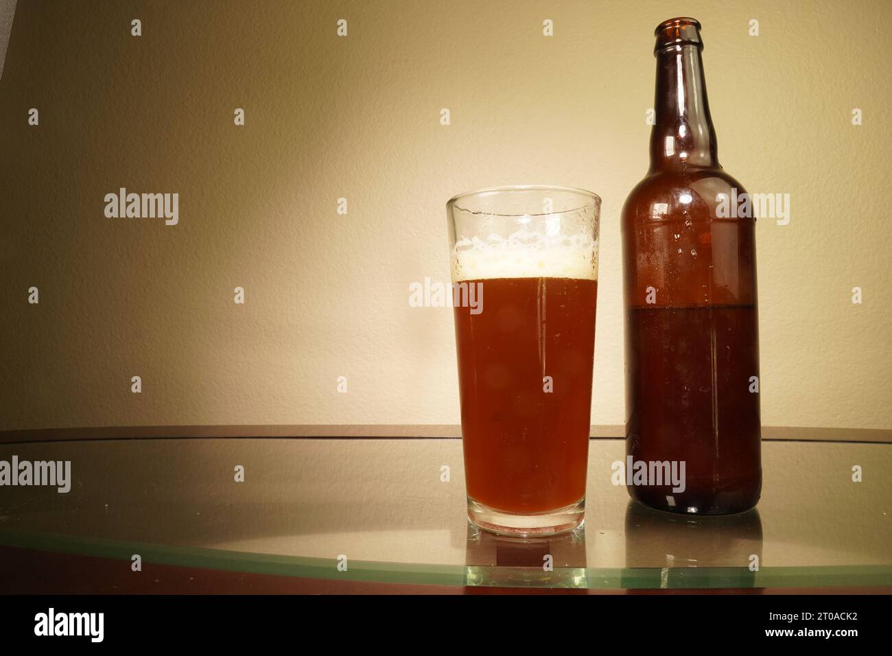A brown beer bottle and pint glass- a symbol of homebrewing and ...