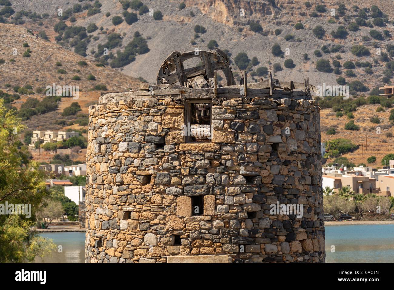 The ruins of ancient windmills along the beach in the Elounda region of ...