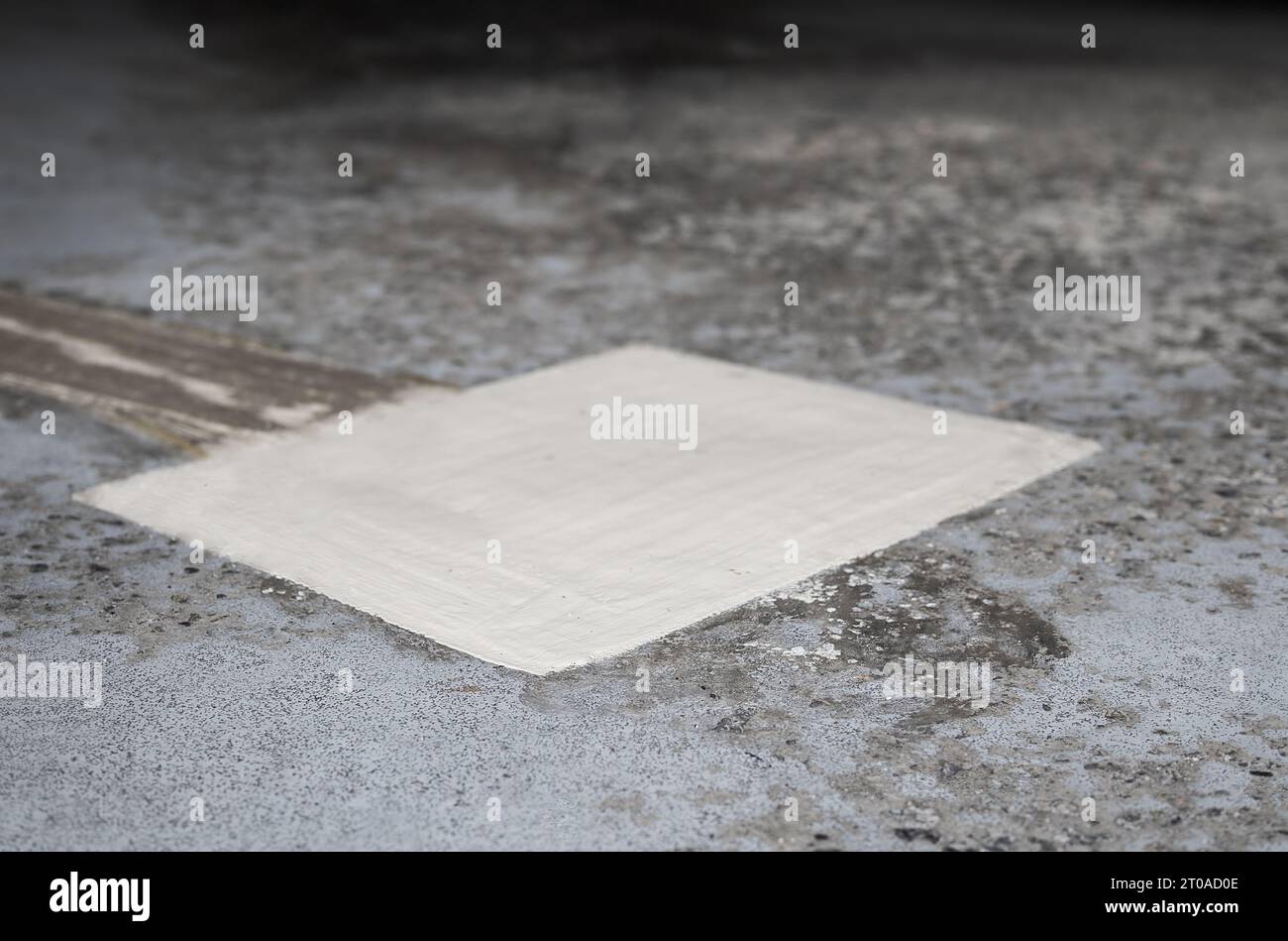 Small driveway repair patch up with waterproofing sealant. Polymethyl ...