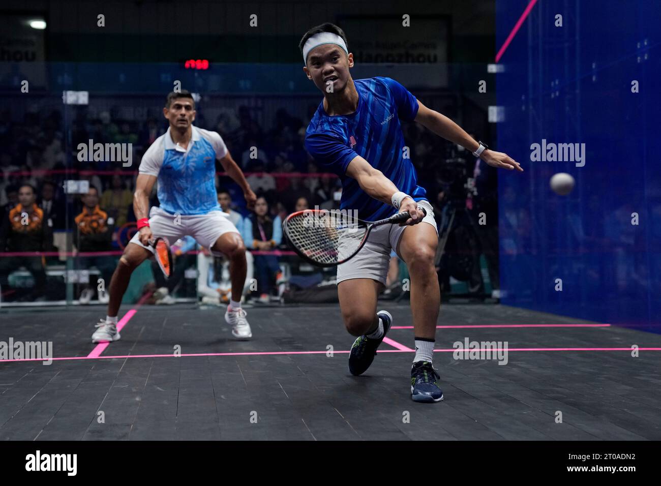 Malaysia's Eain Yow Ng, right, competes with India's Saurav Ghosal ...